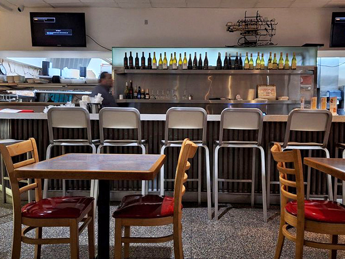 The counter seating offers front-row tickets to the culinary show, where coffee cups are never empty and conversation flows as freely as the syrup.