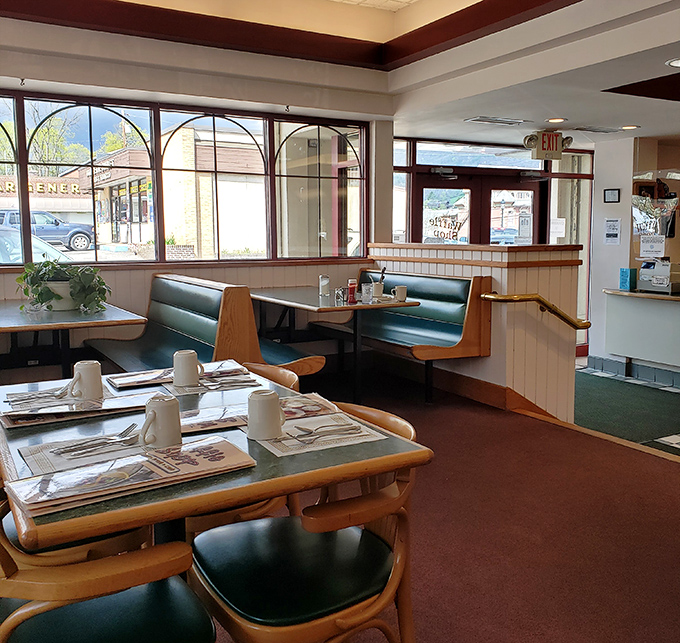 Classic diner booths and tables bathed in natural light—the stage where breakfast dreams come true and coffee refills appear like magic.