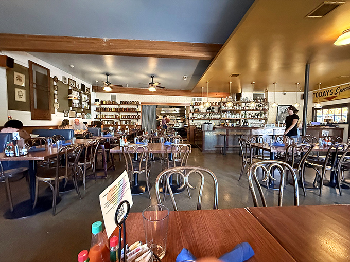 The dining room hums with anticipation as bentwood chairs cradle hungry patrons beneath exposed wooden beams and that signature "Today's Specials" sign.