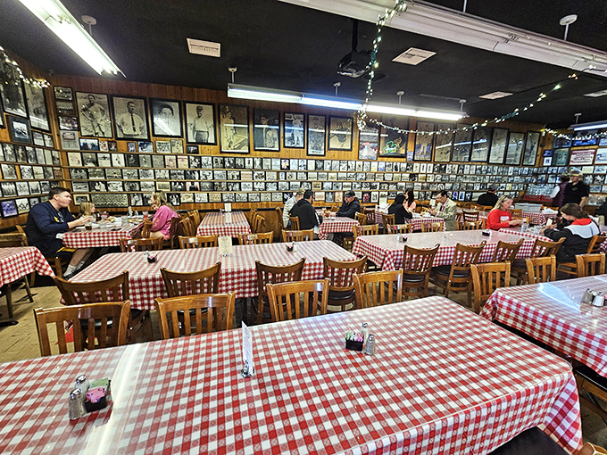 The dining room wall&mdash;plastered with decades of photographs&mdash;serves as both decoration and proof that you're eating somewhere that matters.