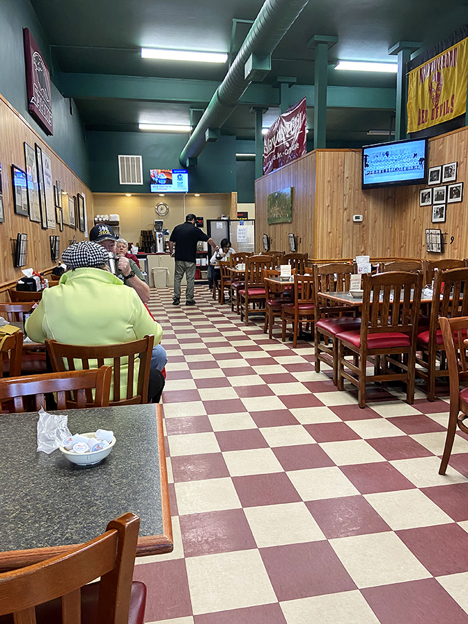 The checkered floor and wooden paneling haven't changed in decades. In an era of Instagram-designed restaurants, this authentic charm feels revolutionary.