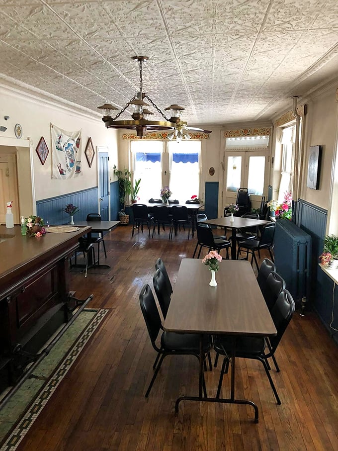 Wooden floors that have witnessed decades of satisfied diners, fresh flowers on every table, and a ceiling that could tell stories of countless celebrations.