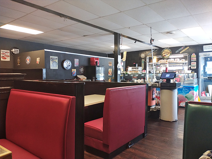 Red vinyl booths that have probably heard more family stories than most therapists, set against walls of automotive memorabilia.