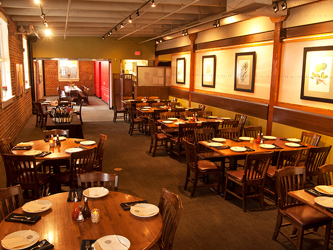 Warm wood tones, exposed brick, and thoughtfully spaced tables create the perfect backdrop for the serious business of barbecue appreciation.