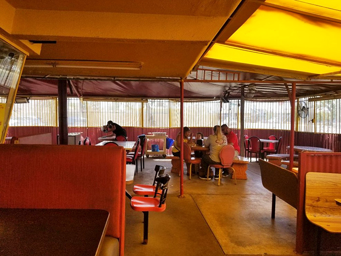 The covered patio dining area offers casual comfort where families gather to share meals and create lasting food memories together.