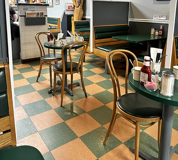 The quintessential diner setting: green tables, bentwood chairs, and that checkerboard floor that's witnessed countless morning conversations and coffee refills.