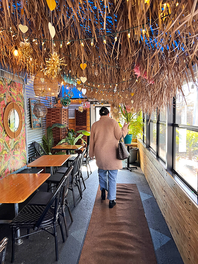 Walking through this thatch-ceiling corridor feels like entering a secret tropical clubhouse where delicious memories are about to be made.