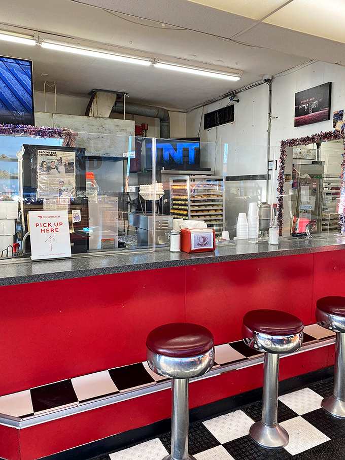 Classic diner stools where countless morning conversations have been sweetened by sugar and friendship.