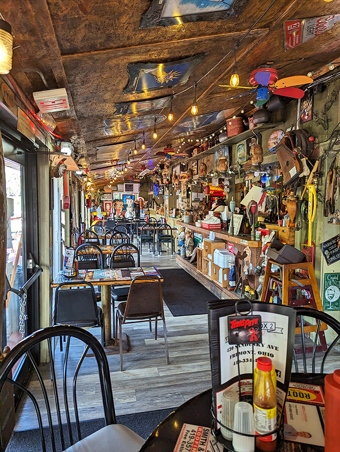 The dining area stretches like a museum of Americana, where string lights cast a warm glow over tables that have hosted countless conversations and celebrations.