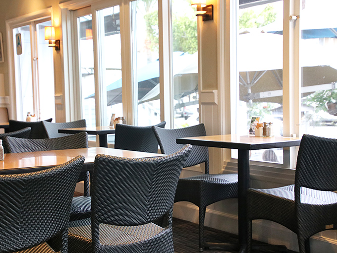 Sunlight streams through windows in this dining area where every table feels like the best seat in the house.