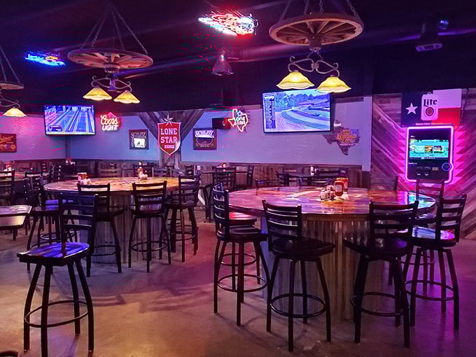 The bar area combines Texas nostalgia with modern comforts&mdash;wagon wheels hanging from the ceiling while sports play on flat-screens.