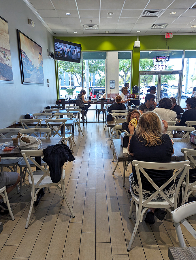 The dining room hums with satisfied customers. White crossback chairs and bright accents create the perfect backdrop for the main event &ndash; those incredible bagels.