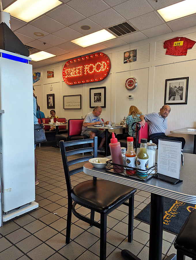 That "GREAT FOOD" sign isn't just decoration &ndash; it's truth in advertising. Red booths and condiment caddies create the classic American diner experience.