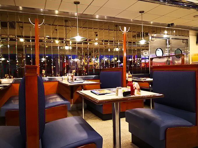 The evening light transforms the dining area into a cozy retreat. Those blue booths have heard decades of first dates, family celebrations, and everyday stories.