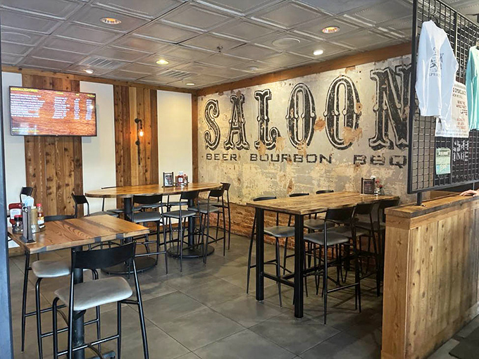The "SALOON" dining area combines high-top tables with rustic wood elements, creating the perfect backdrop for serious barbecue contemplation.
