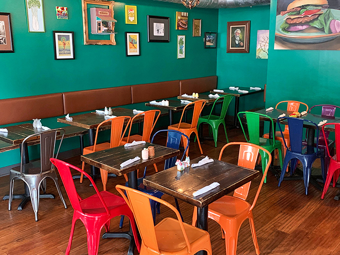 The dining room's rainbow of metal chairs against teal walls creates the perfect backdrop for the serious business of burger appreciation.