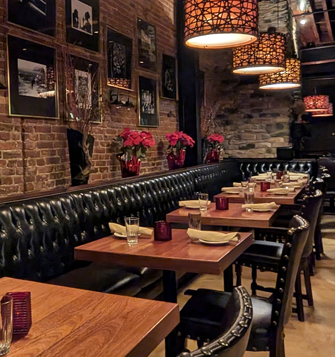 Leather banquettes, brick walls, and wooden tables create the holy trinity of steakhouse ambiance. Those pendant lights cast the perfect glow.