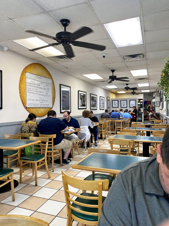 The dining room buzzes with the energy of satisfied customers, where ceiling fans and conversation create the perfect breakfast symphony.