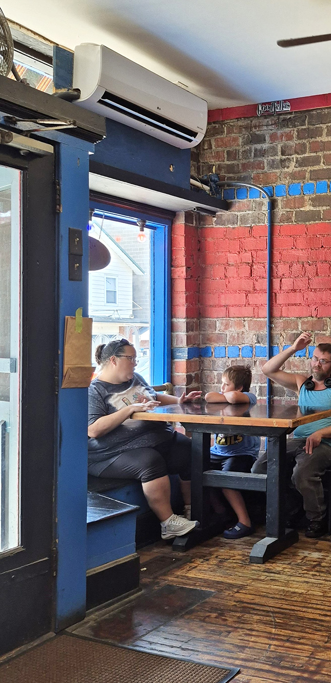 Exposed brick walls and wooden tables create the perfect backdrop for pizza-fueled conversations and memories.