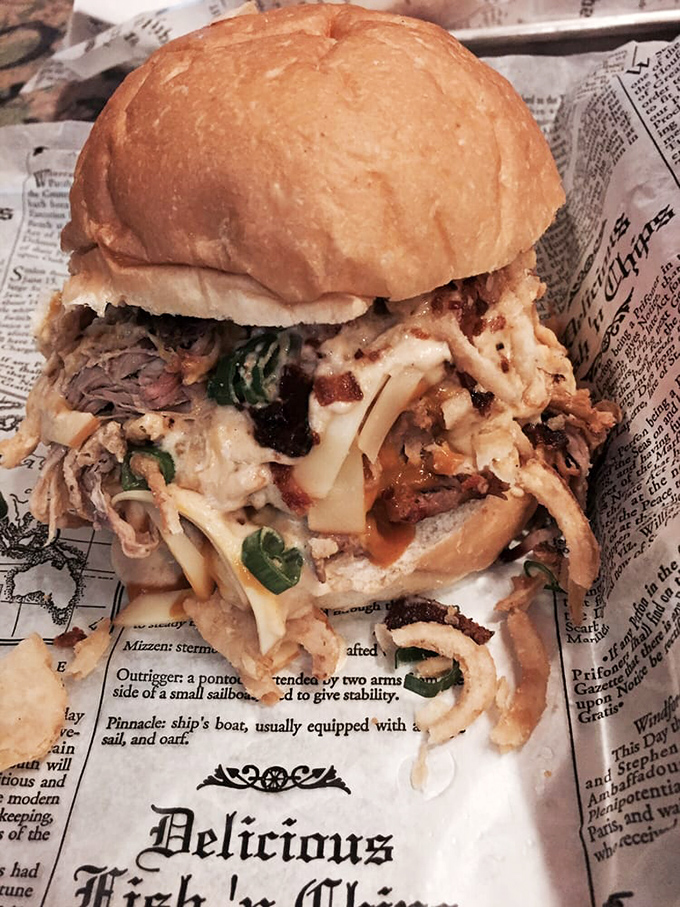 The "Delicious" stamp isn't false advertising. This towering sandwich, wrapped in newspaper like a gift, combines pulled pork and melty cheese in perfect harmony.