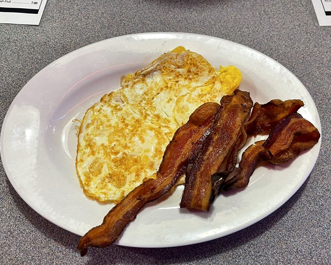 Eggs and bacon arranged like a breakfast still life that would make Norman Rockwell proud.