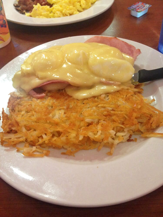 Hash browns crisped to golden perfection, crowned with ham and hollandaise &ndash; breakfast architecture that would make Frank Lloyd Wright order seconds.