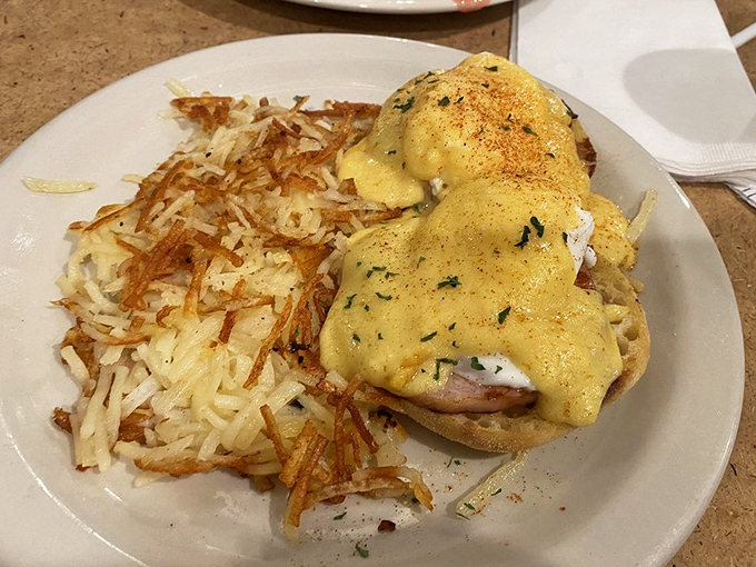 Eggs Benedict that's dressed better than most people at church. Those crispy hash browns are the supporting actor deserving their own Oscar.