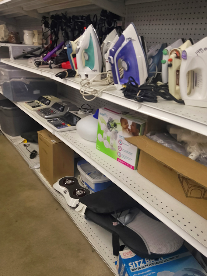 Shelves of small appliances wait patiently, each iron standing at attention like soldiers in a domestic army.
