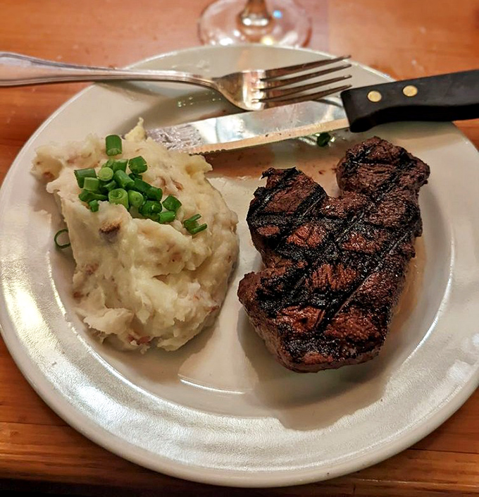 This filet mignon with garlic mashed potatoes isn't just dinner—it's edible velvet. The grill marks are practically autographs from a meat master.