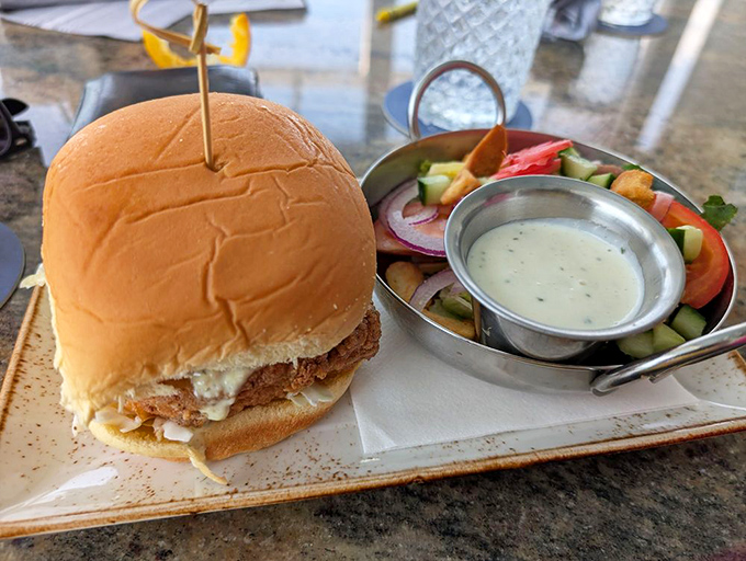 A fish sandwich that makes other sandwiches question their life choices, dressed to impress between toasted perfection.