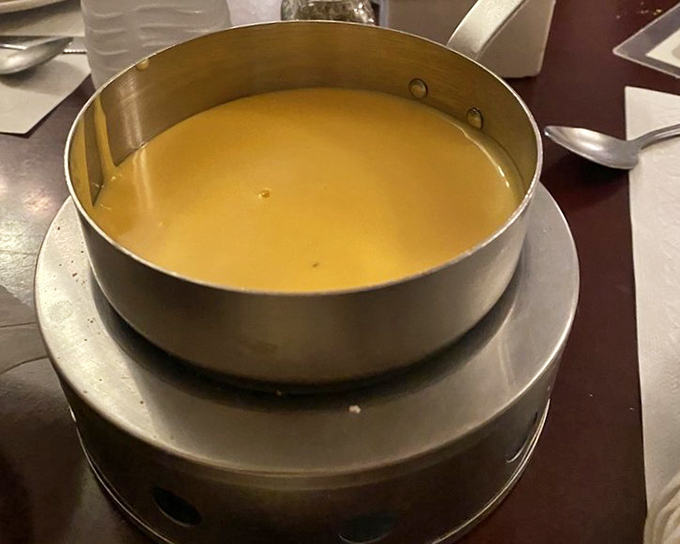 The fondue arrives like liquid gold in its metal chalice&mdash;a communal pot of joy waiting to transform ordinary bread into extraordinary memories.