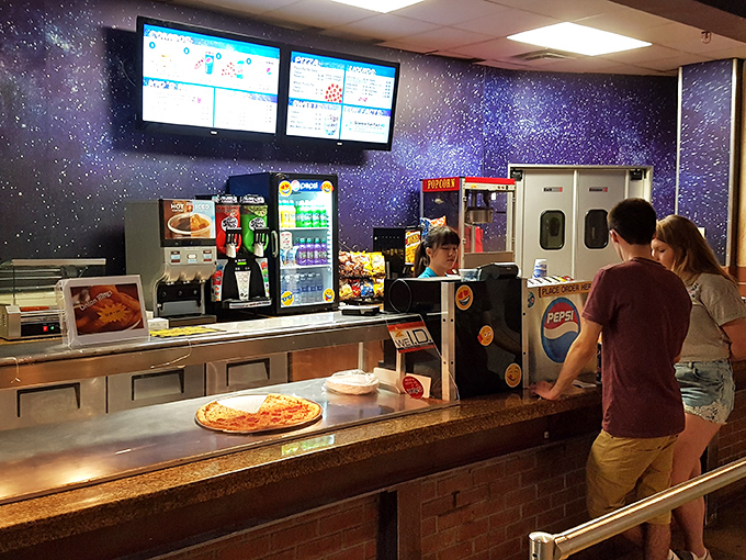 Even the snack counter embraces the space theme, serving up pizza under a cosmic backdrop. Eating lunch while contemplating the universe!