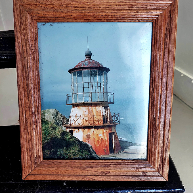 Before Instagram filters existed, lighthouses aged naturally. This framed photo shows the structure in its weathered, rust-streaked glory.