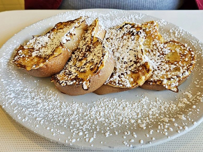 French toast that makes you question every other breakfast you've ever had. Powdered sugar snowfall on golden bread&mdash;pure morning magic.