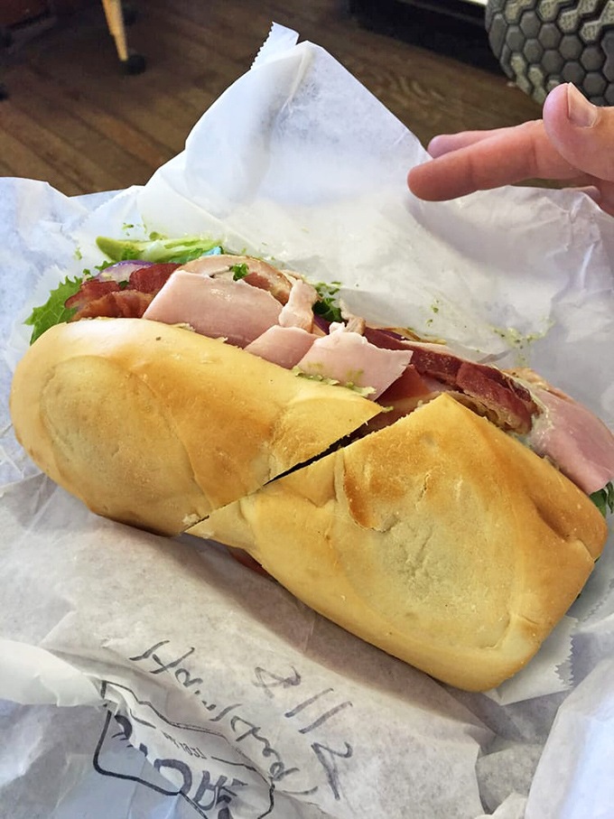 A sandwich so fresh and inviting, you can practically hear the crunch of that baguette through the photo. Lunch perfection, wrapped in paper.