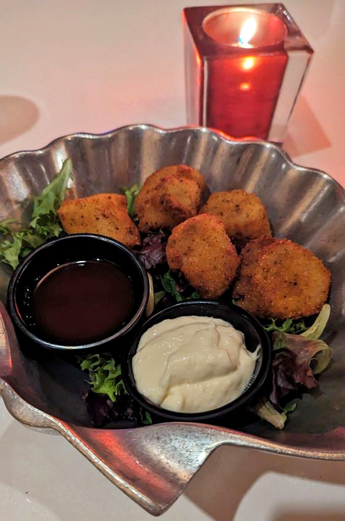 Golden-fried treasures nestled in a scalloped silver dish. These aren't just appetizers&mdash;they're little crispy preludes to the main event.