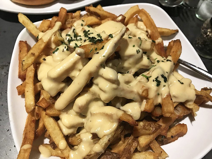 These aren't just cheese fries—they're a commitment to excellence. The generous cheese blanket transforms humble potatoes into something worth fighting over.