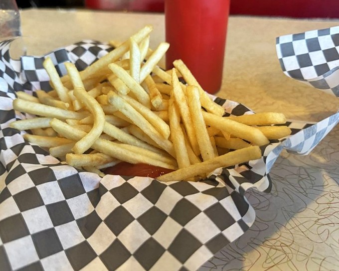 Fries that understand their purpose in life: crispy vessels for ketchup delivery that still maintain their potato dignity.
