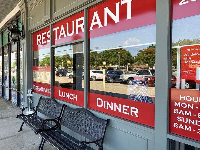 The storefront promises three essential food groups: Breakfast, Lunch, and Dinner. A sidewalk bench for post-meal contemplation included.