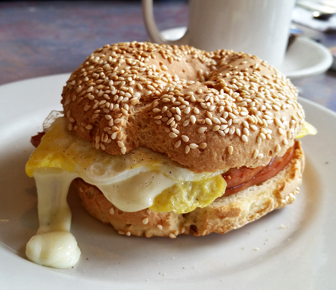 Breakfast sandwich nirvana&mdash;where melty cheese cascades over perfectly cooked egg and meat, all embraced by a toasty sesame bagel.
