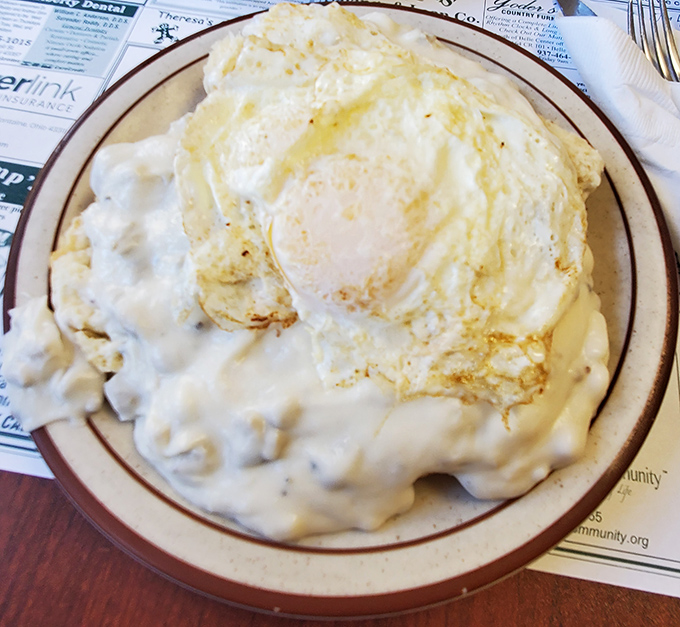 Biscuits and gravy with eggs&mdash;the holy trinity of breakfast comfort that says "Good morning" like a warm hug from your favorite aunt.