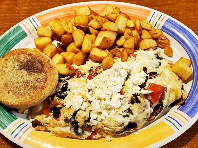The Greek omelet brings Mediterranean sunshine to Florida mornings. Feta cheese and olives having a party that tomatoes crashed.