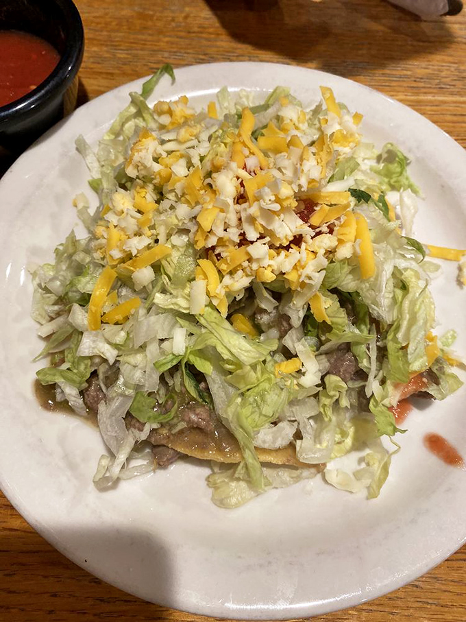 Green chili tostada showcasing the perfect balance of crispy textures and bold southwestern flavors.