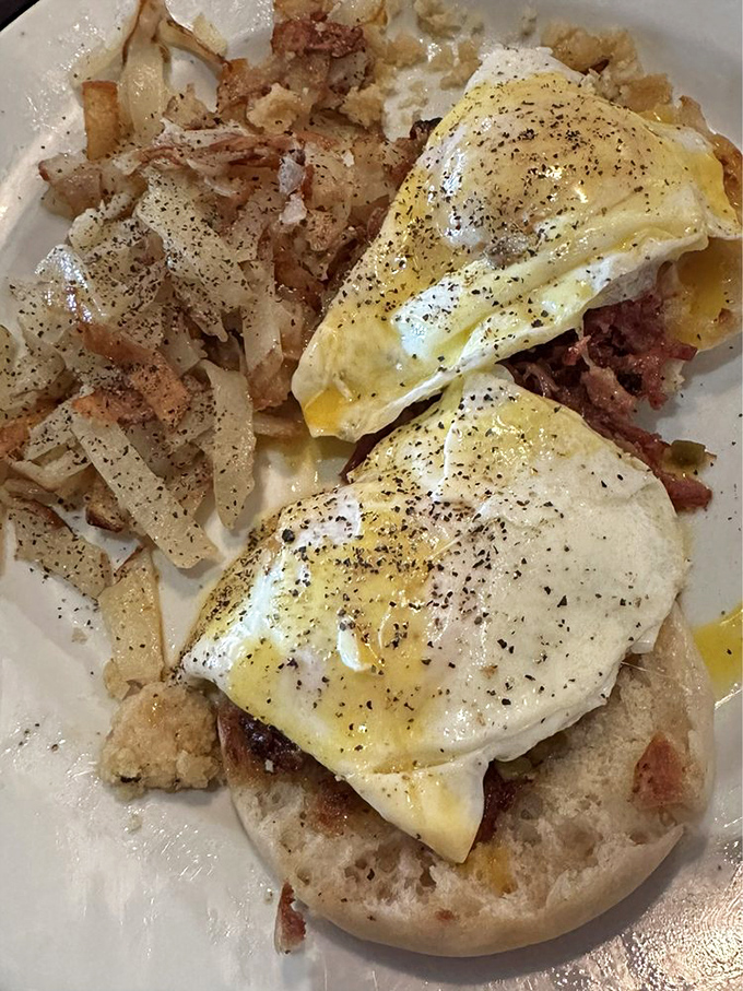 When English muffins meet perfectly poached eggs atop a mountain of hash browns&mdash;breakfast architecture at its finest.