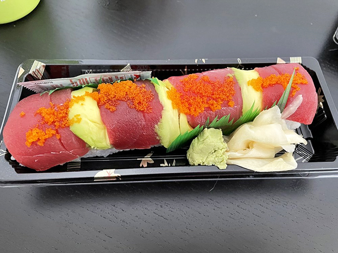 A Hawaiian roll that's dressed to impress &ndash; alternating slices of tuna and avocado topped with vibrant tobiko, like a tropical vacation for your taste buds.