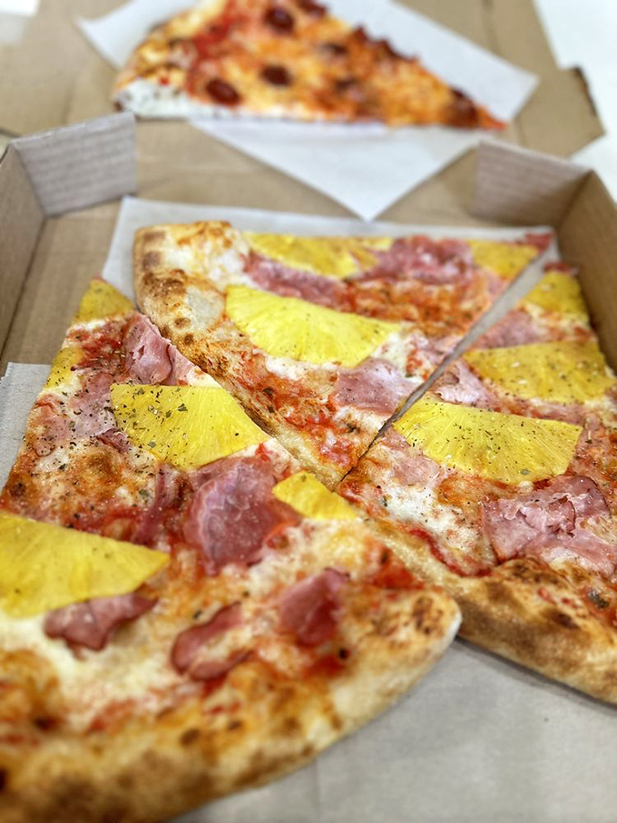 The controversial Hawaiian&mdash;yellow pineapple squares and ham creating a sweet-savory debate on a pizza canvas. Even purists might be converted here.