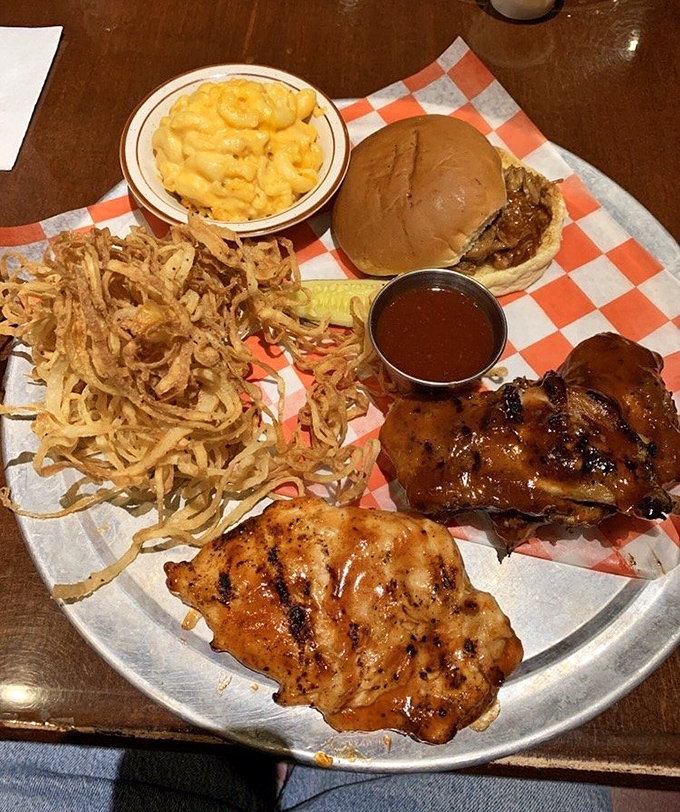 The signature BBQ platter delivers a carnivore's dream with ribs, chicken, and all the fixings.
