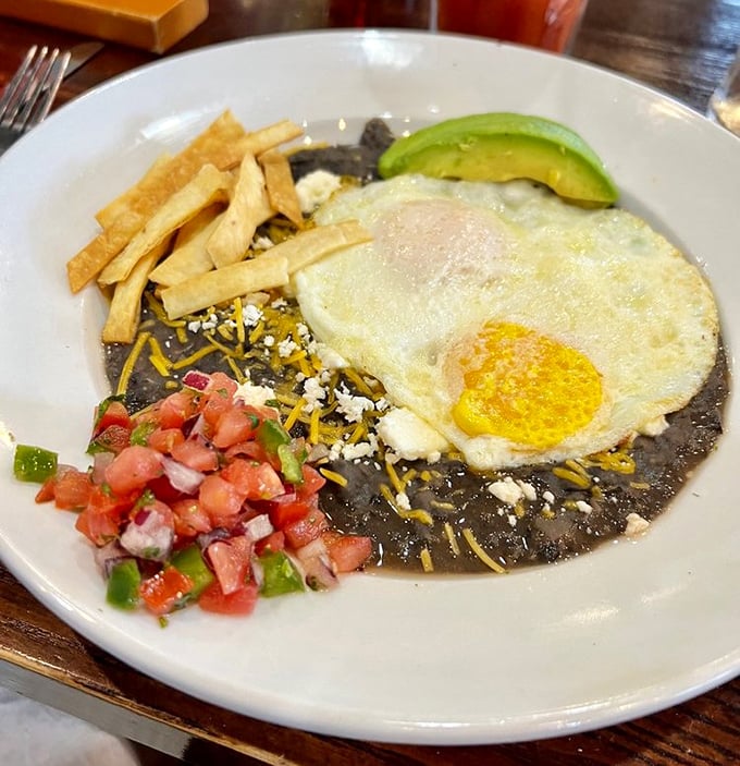 Huevos Rancheros bringing the fiesta to your morning. Black beans, fresh pico, and that perfectly fried egg&mdash;a breakfast worth crossing borders for.