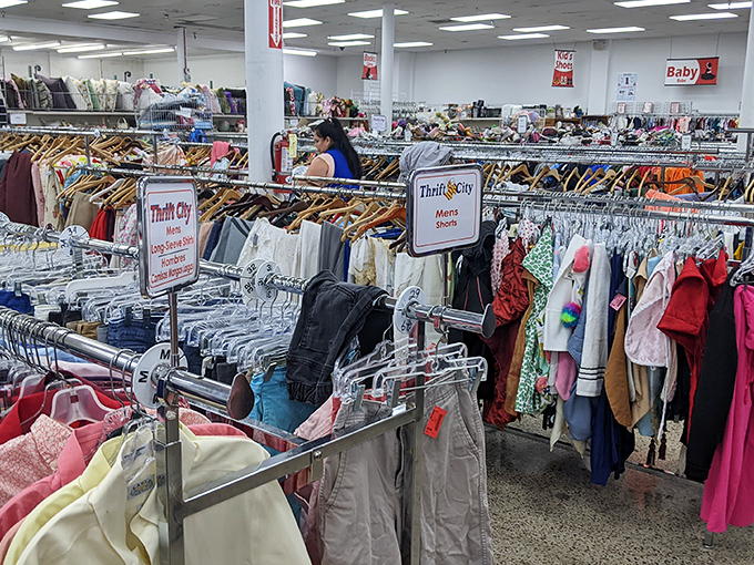 Thrift City's clothing department stretches toward the horizon, a textile ocean where fashion trends of every decade collide.