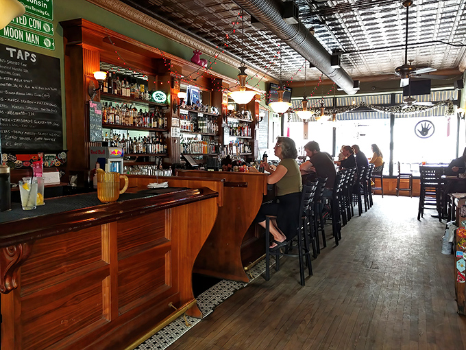 The bar beckons with promises of craft beers and spirited conversations. Wisconsin hospitality flows as freely as the taps.